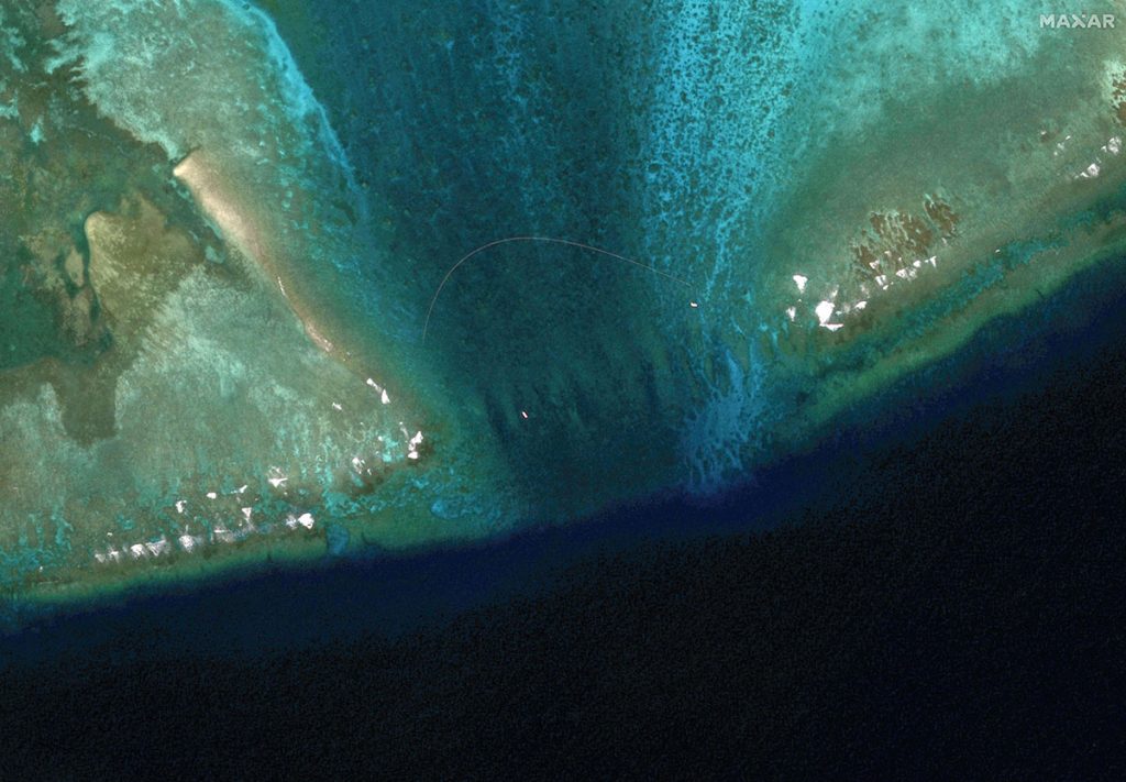 Satellite images reveal floating barrier at mouth of disputed atoll in ...